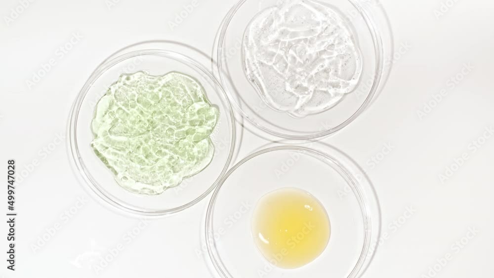 Rotation of Petri dishes with cosmetics samples on a white background ...