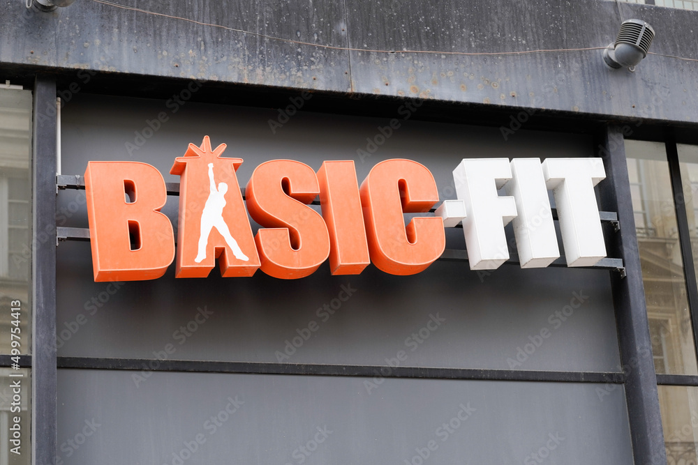 Basic Fit logo sporty fitness club sign and text brand on wall facade ...