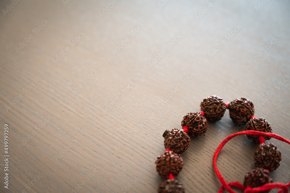 Rudraksha beads rosary isolated on gray color wooden background. Symbol ...