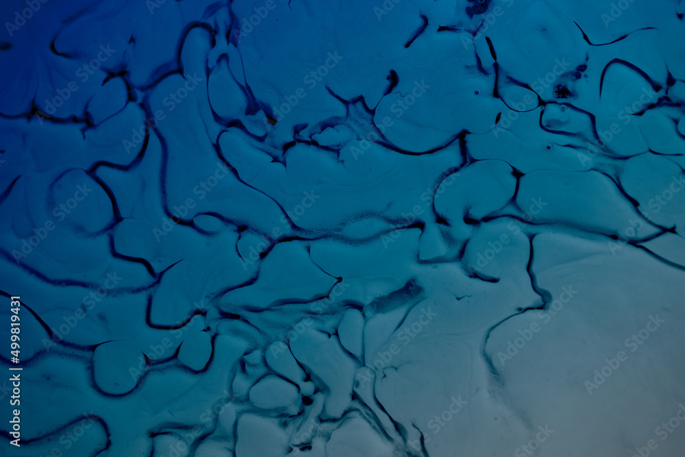 An art image with blue paint effects and milk creating abstract ...