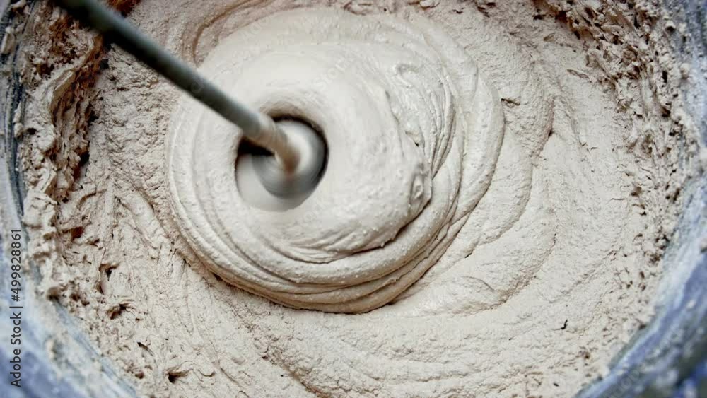 mixing the plaster mixture in a bucket with a drill Stock ビデオ | Adobe Stock