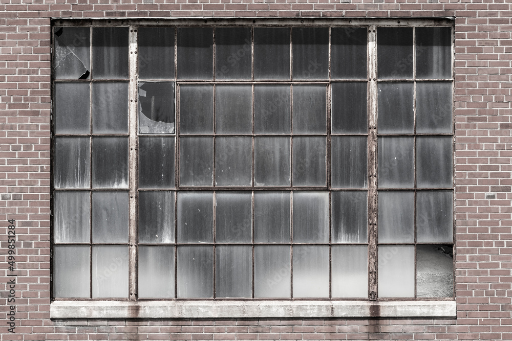 Broken windows and worn exterior of an abandoned coal power plant. Coal ...