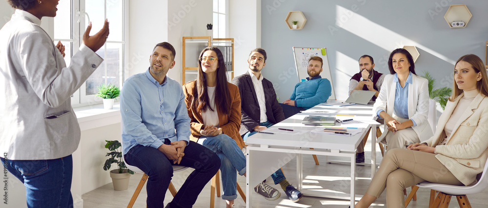 Group of people at a business meeting. Team leader speaking to her ...