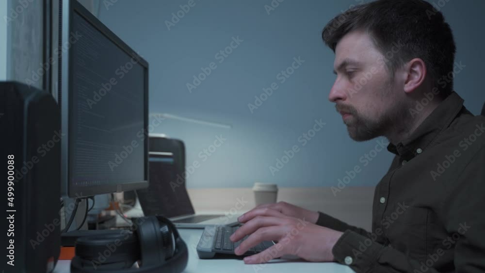 Computer programmer working at his desk at home. Male development ...