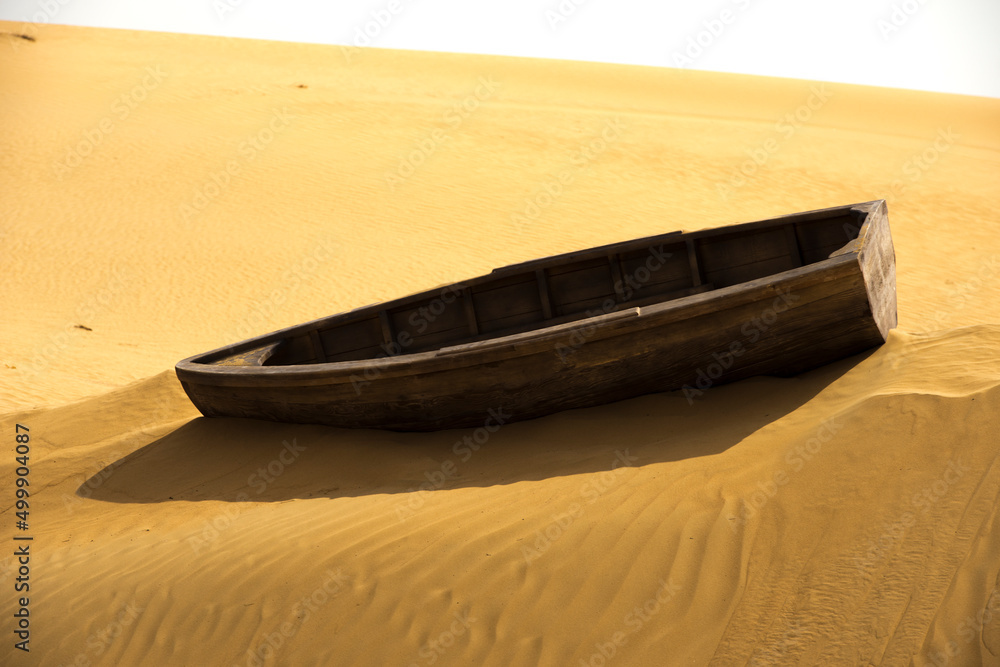 wooden boat covered with sand in the sandy sea of the desert Stock ...