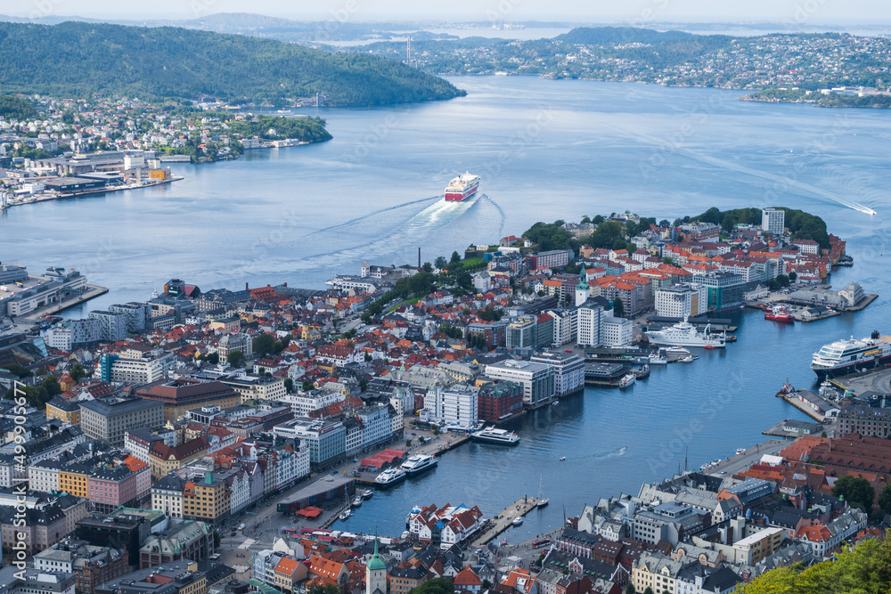 Bergen cityscape surrounded by mountains with sailing cruise ship, fish ...