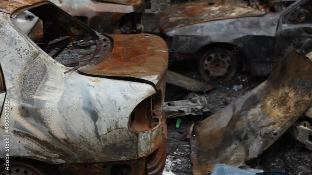Burnt and damaged cars of civilians as a result of a military attack on ...