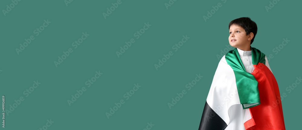 Cute little boy with national flag of UAE on green background with ...