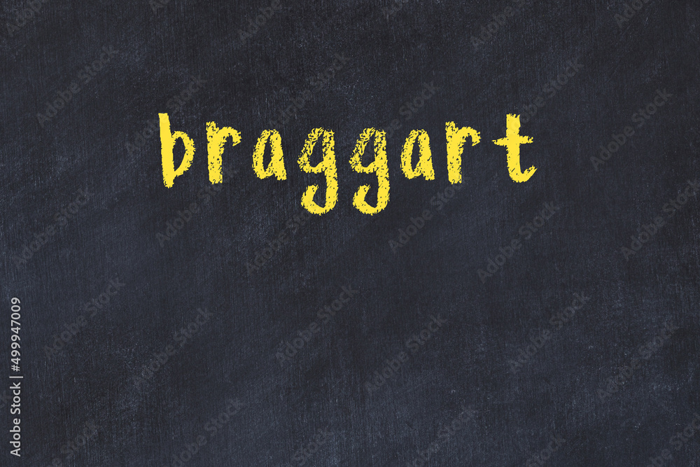 College chalk desk with the word braggart written on in Stock Photo ...
