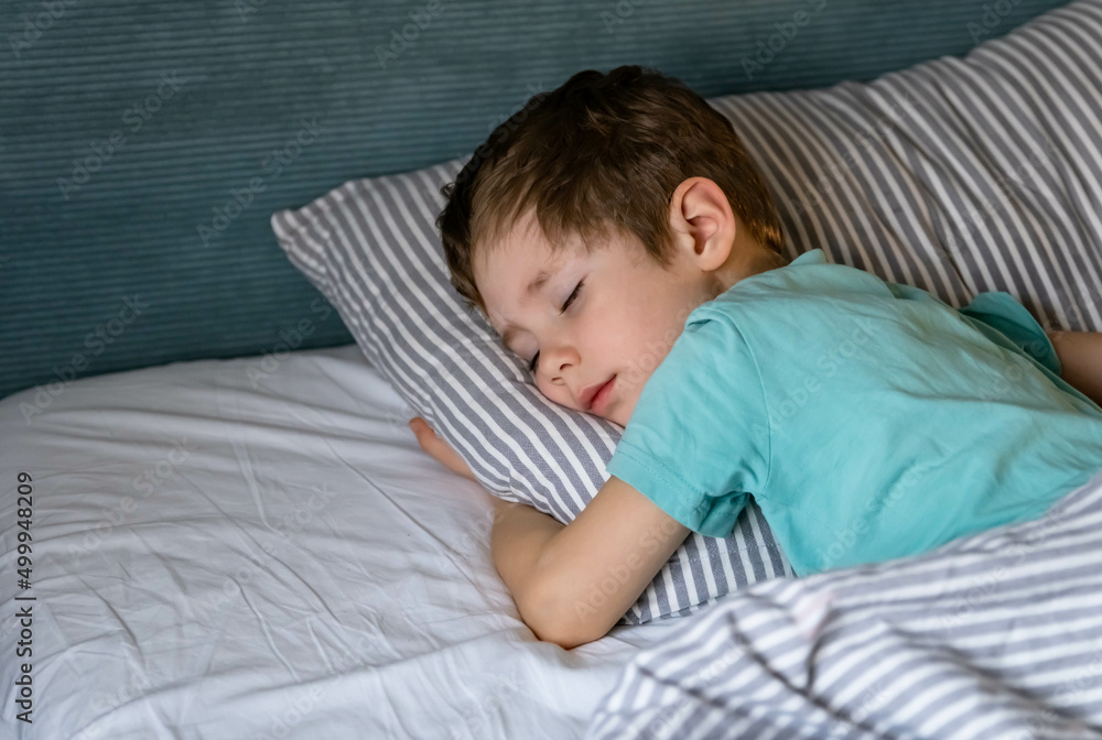 Sleeping child in bed. Little baby napping in the nursery. Closeup boy ...