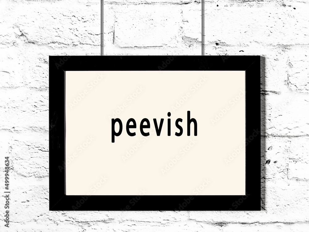 Black frame hanging on white brick wall with inscription peevish Stock ...