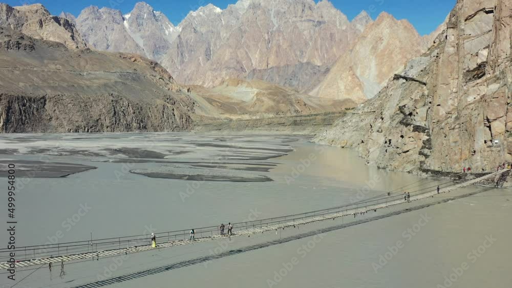 Aerial drone of tourists crossing the famous Hussaini bridge in Hunza ...