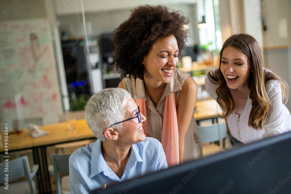 Group of software engineers working developing applications together in ...