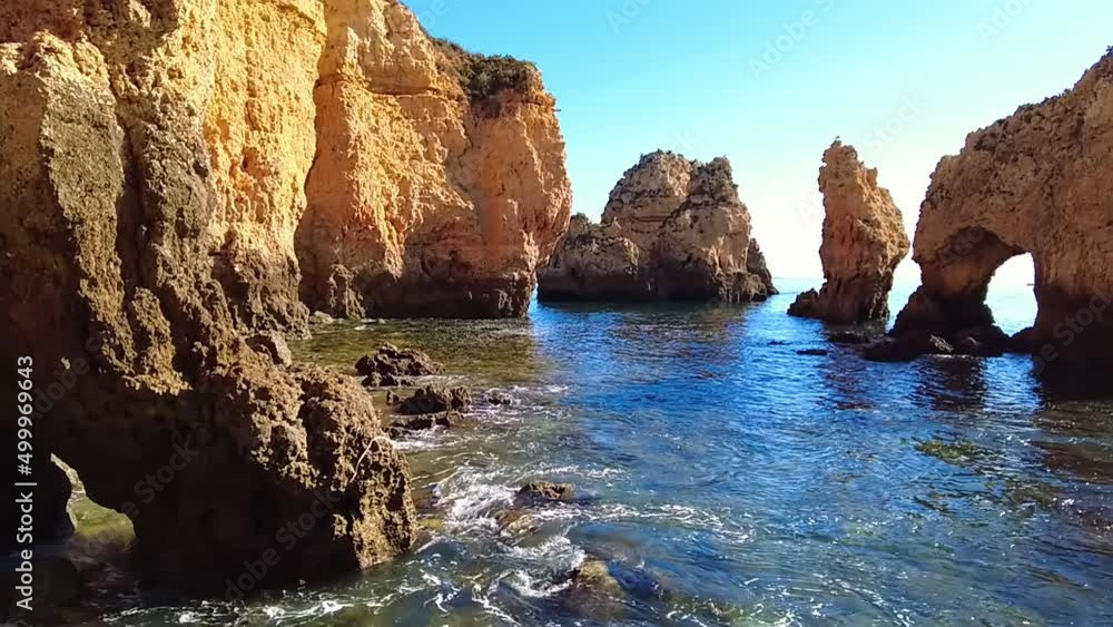 Overlooking limestone cliffs in the blue turquoise ocean. Yellow and ...