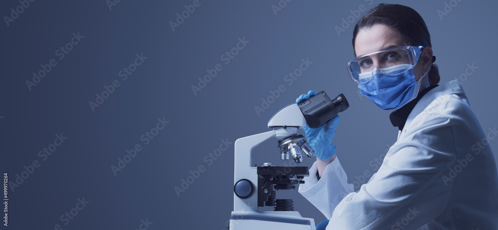 Researcher using a professional microscope Stock Photo | Adobe Stock