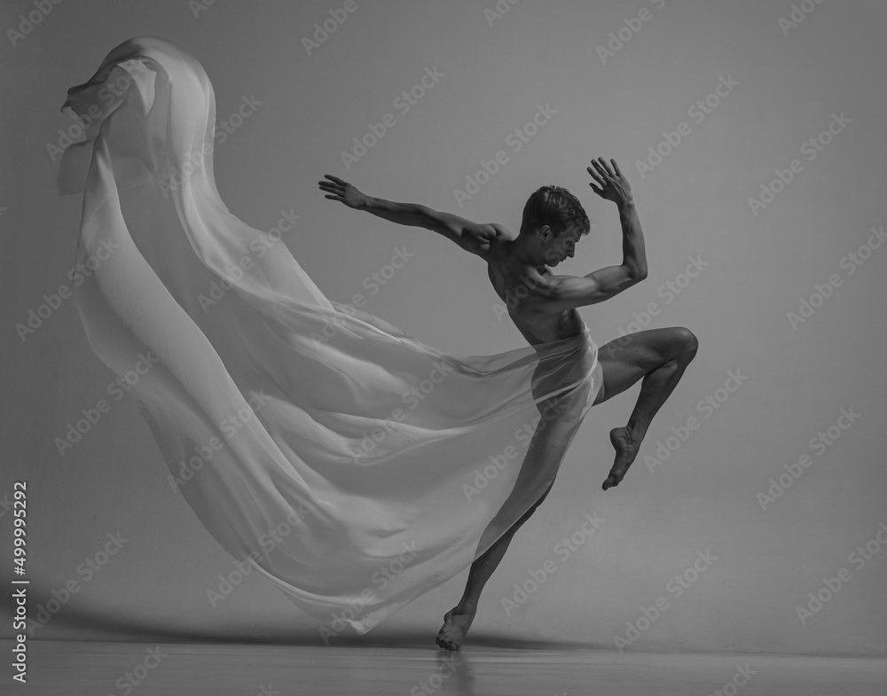 Black and white portrait of graceful muscled male ballet dancer dancing ...