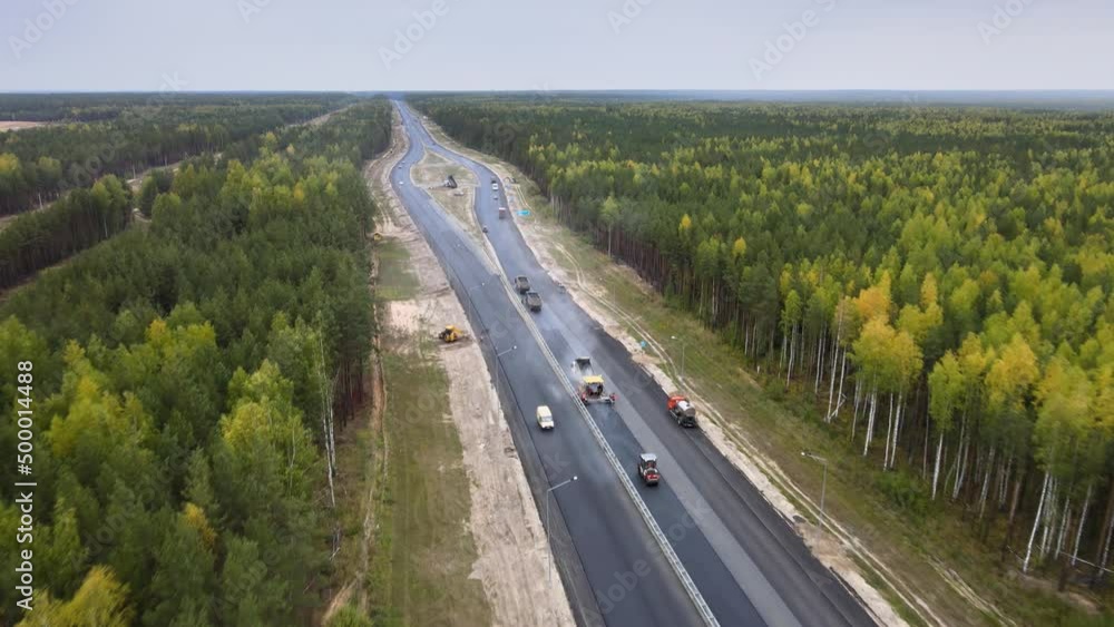 Video „The motorway repairs. Laying new asphalt on a suburban road ...