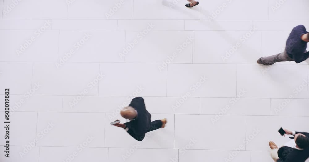 Moving around like busy ants. Overhead of a group of business people ...