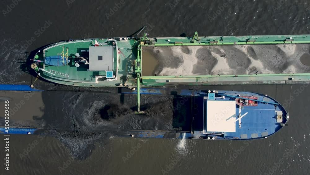 Dredging ship dredges off mud from river bottom to improve the fairway ...