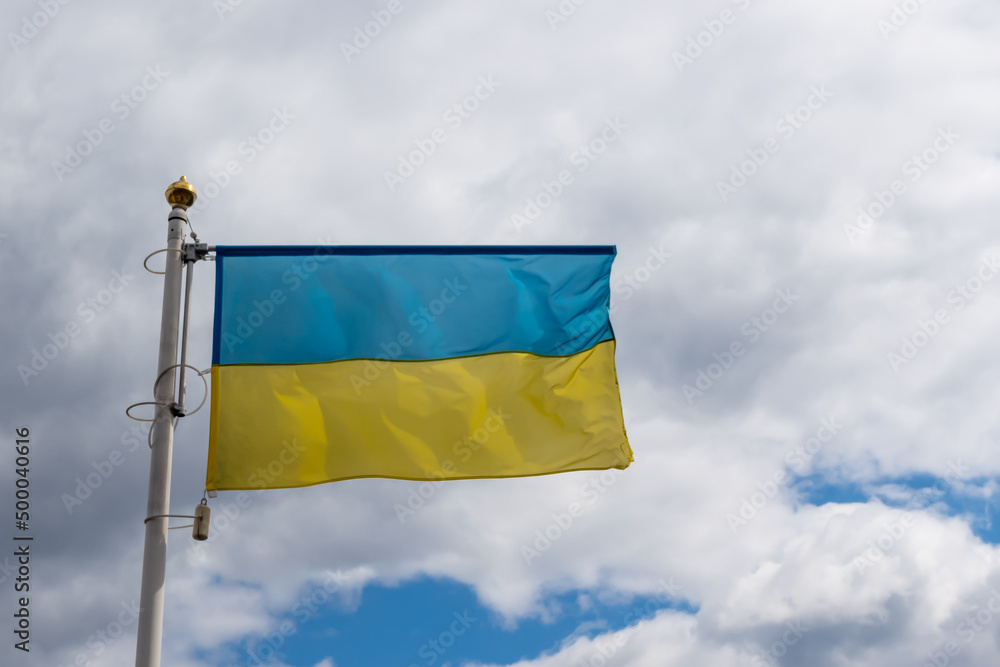 Ukrainian banner wave on the background of cloudy, dramatic sky ...