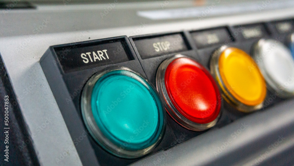 Close up view of the start push button on the industrial control panel ...