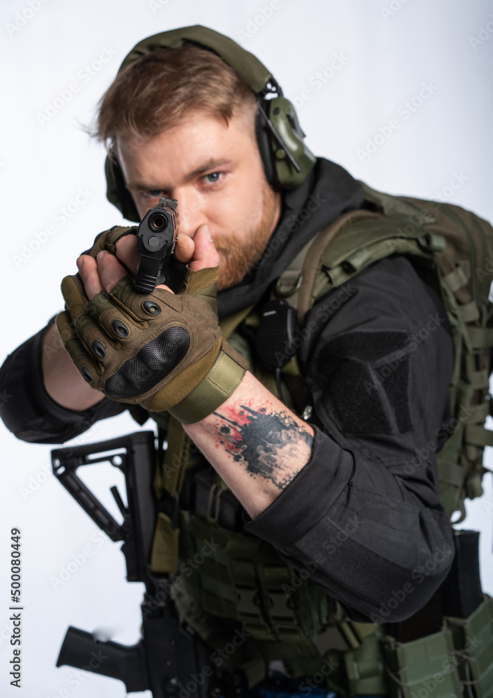 an airsoft player in full gear pointed the muzzle of a pistol at the ...