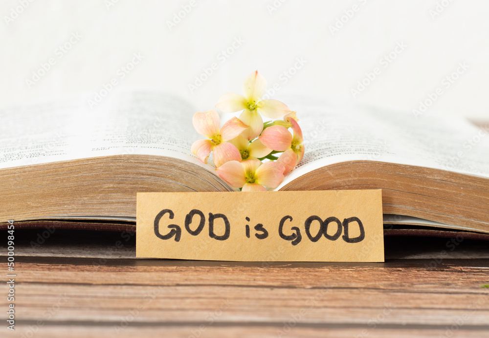 God is Good handwritten quote text with open Holy Bible Book with ...