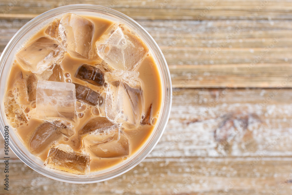 A top down view of an iced milk coffee drink. Stock Photo | Adobe Stock