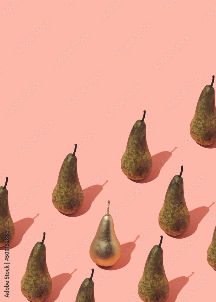 Pattern made of pears with one golden pear.On pastel pink background ...