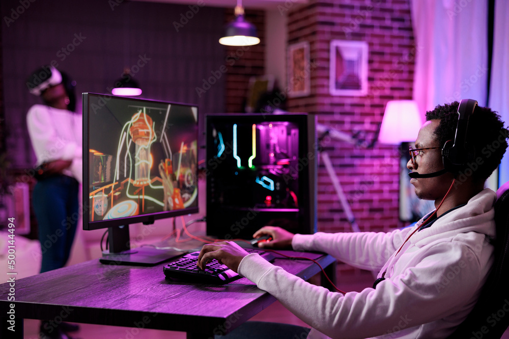 Content creator playing video games competition online at computer ...