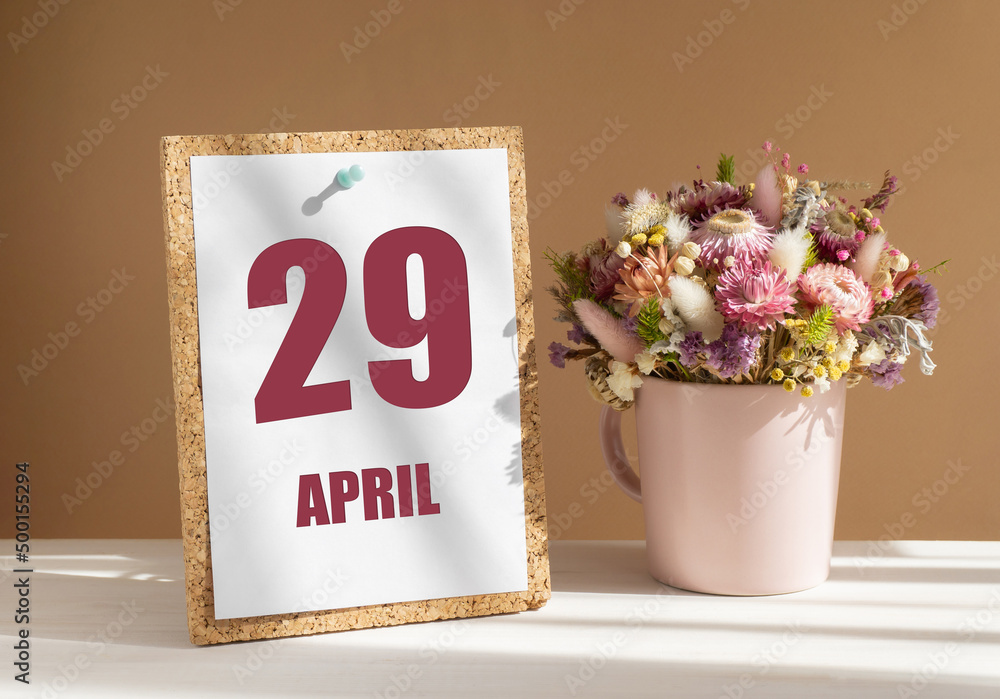 April 29. 29th day of month, calendar date.Bouquet of dead wood in pink ...
