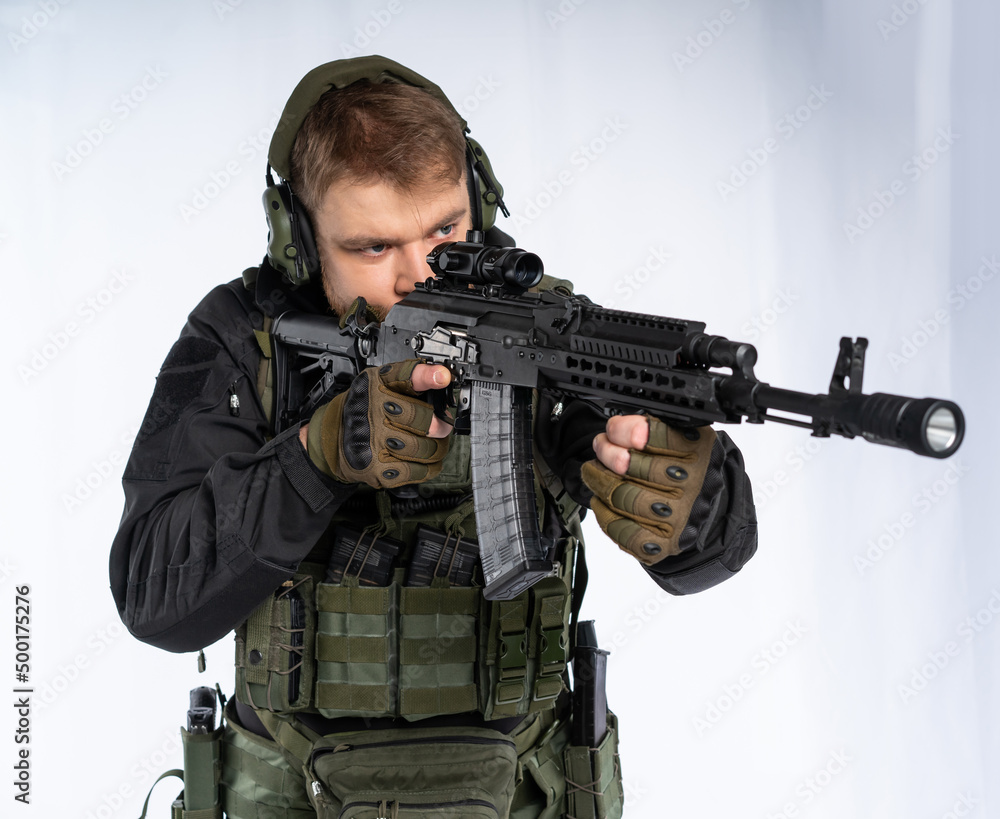 airsoft player in full gear with GG RK74 fire series guns. a man in ...