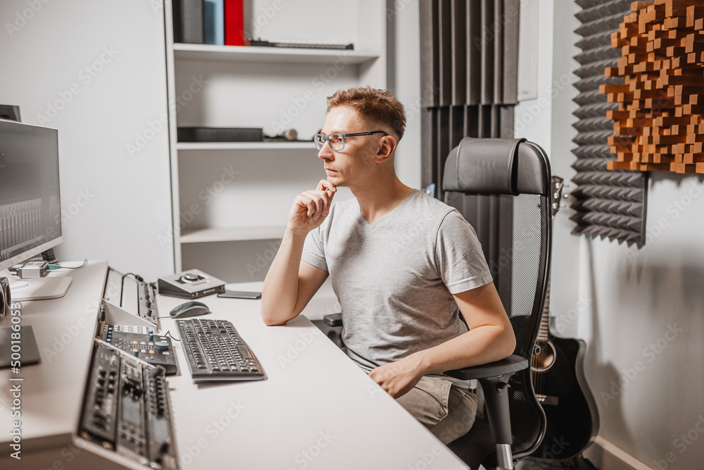 Man working in music studio using computer wearing glasses. Sound ...