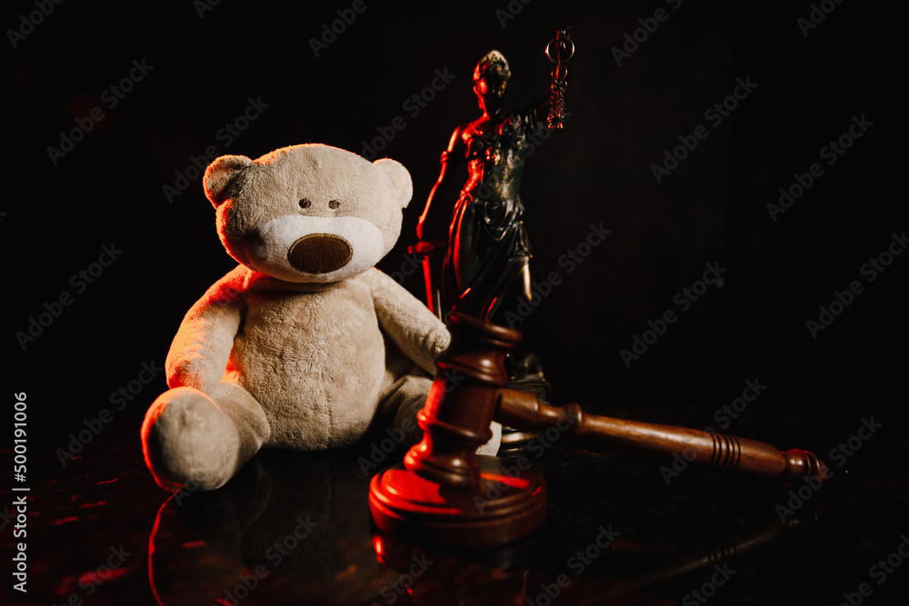 Judge gavel, figure of lady of justice and teddy bear in a court room ...