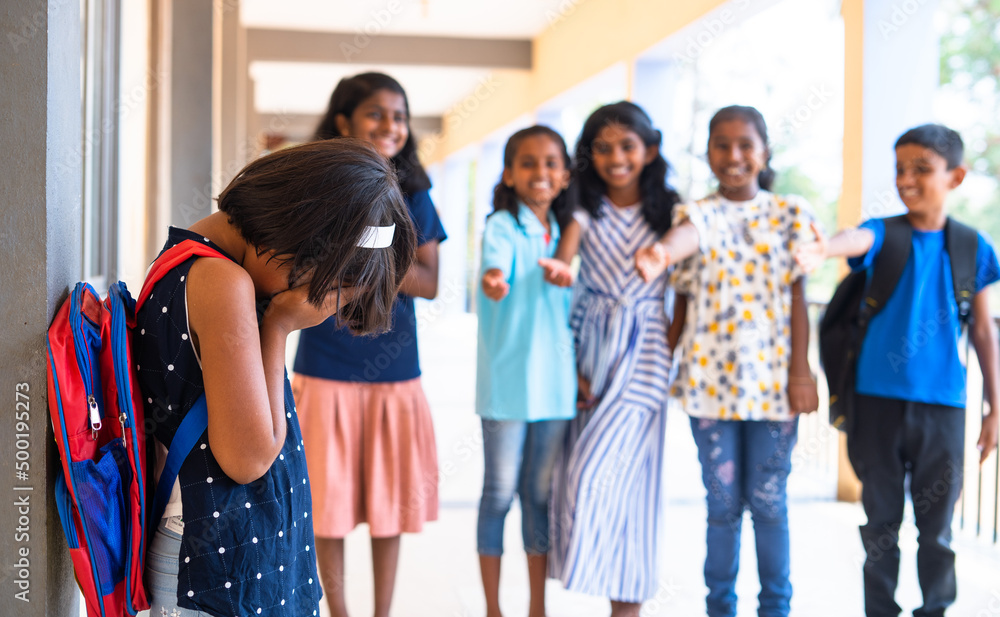 Girl kid being bullied by group of children at school corridor ...