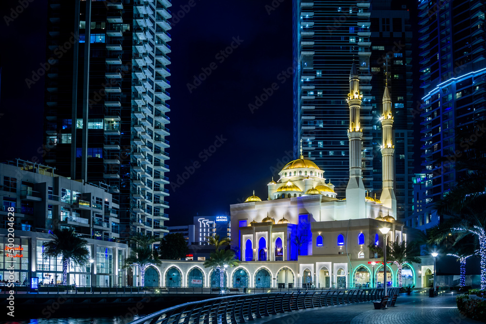 Mohammad Bin Ahmed Al Mulla mosque. Dubai Marina skyline at night Stock ...