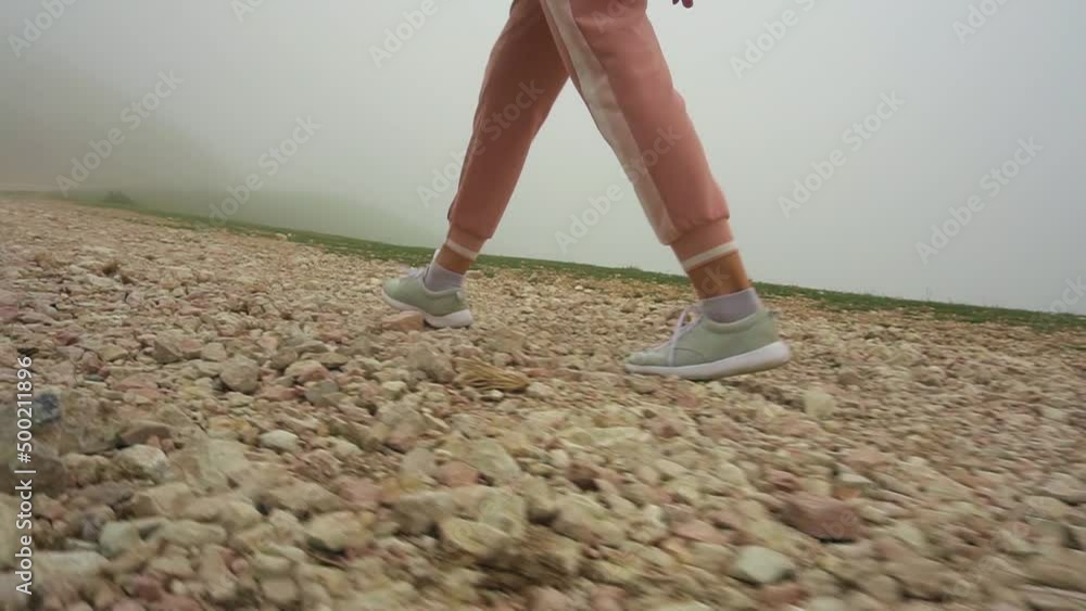 Silhouette woman close-up. girl's legs, stroll steps on wild mountain ...