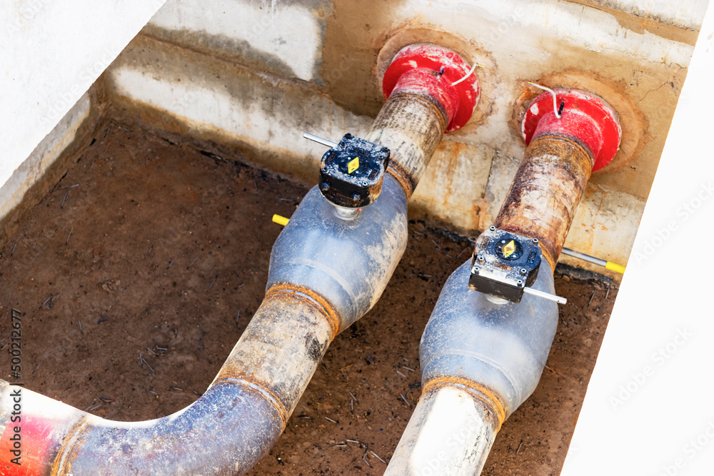 Laying of underground pipes in concrete chamber. Installation of water ...