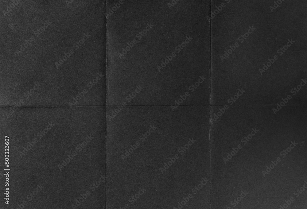 Black crumpled unfolded paper sheet texture background. Paper folded in ...