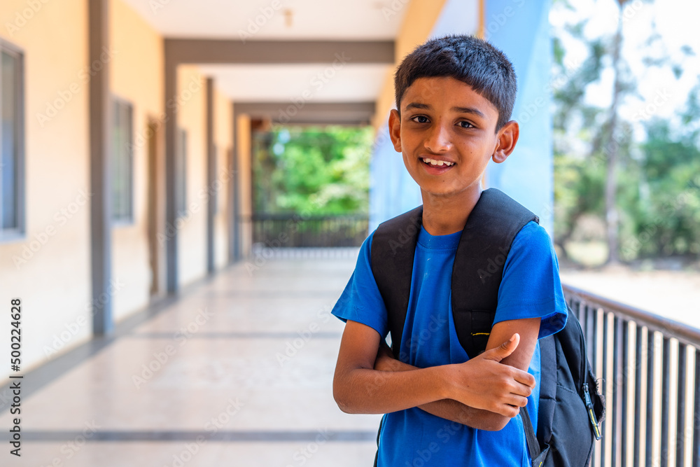 happy smiling kid with backpack confidently standing by with crossed ...