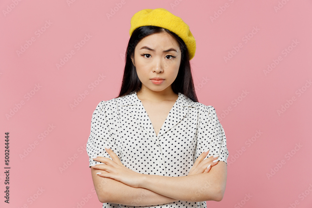 Young sad serious strict woman of Asian ethnicity 20s wear white polka ...