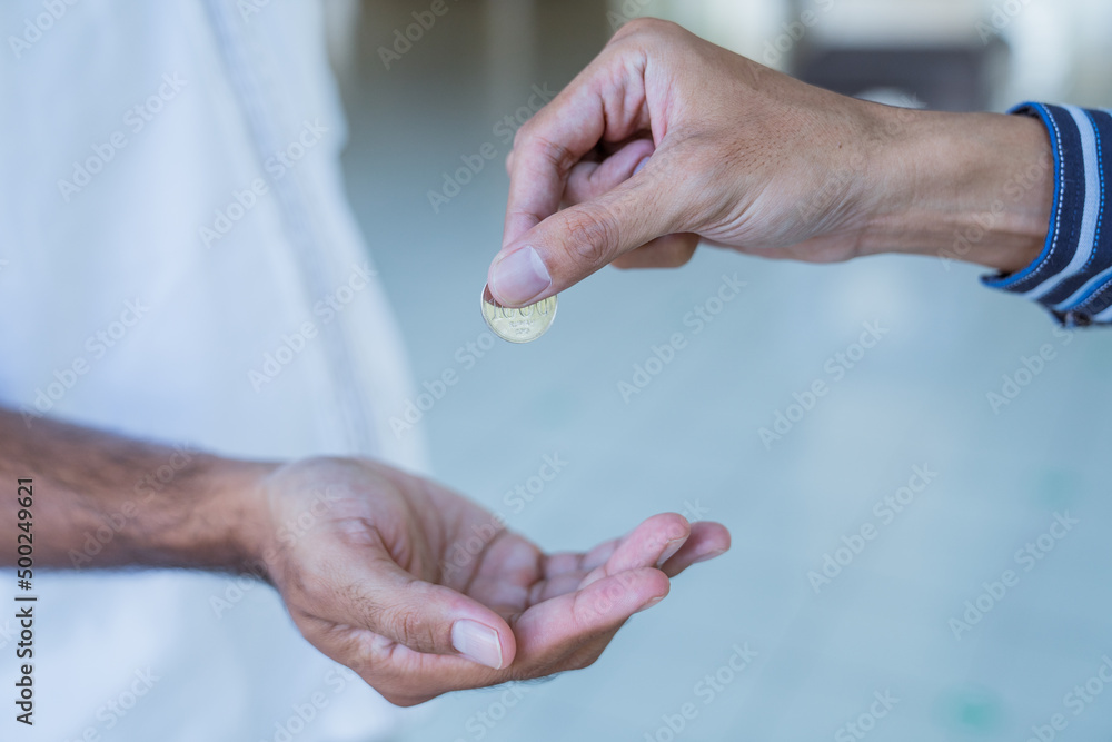 close up of hand giving some money to someone at the mosque Stock Photo ...