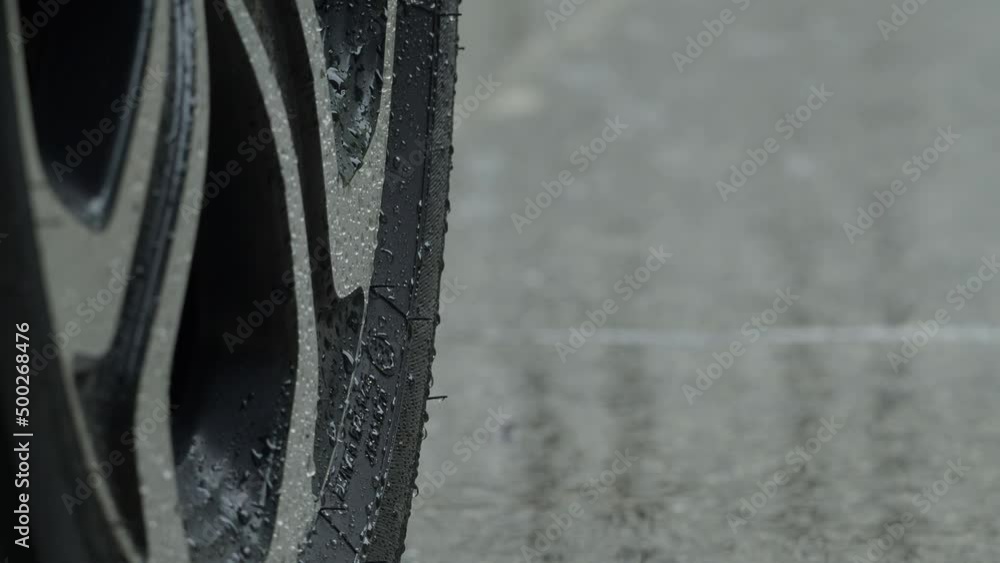 Rain splashing and car tire in rainwater. Car parking in the rain ...