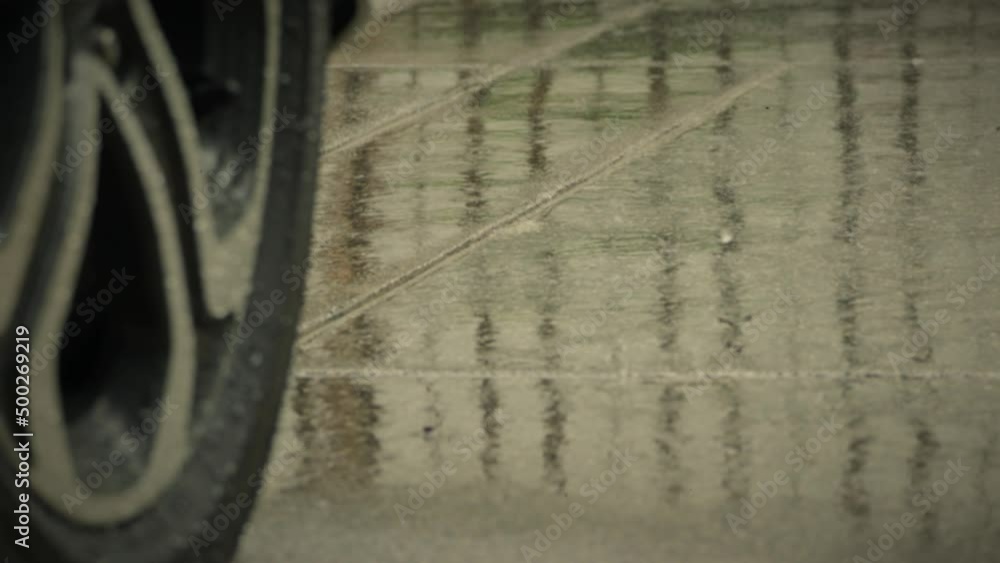 Rain splashing and car tire in rainwater. Car parking in the rain ...