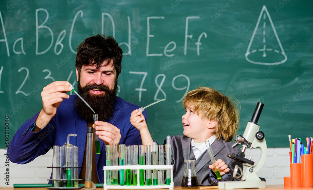 Chemistry is fun. learning chemistry in school laboratory. father and ...