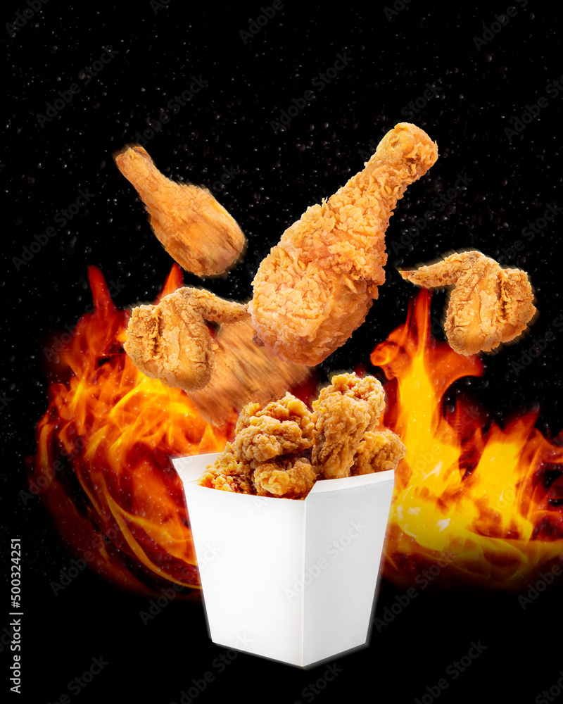 Fried chicken flying out of paper bucket over hot flame background, Hot ...