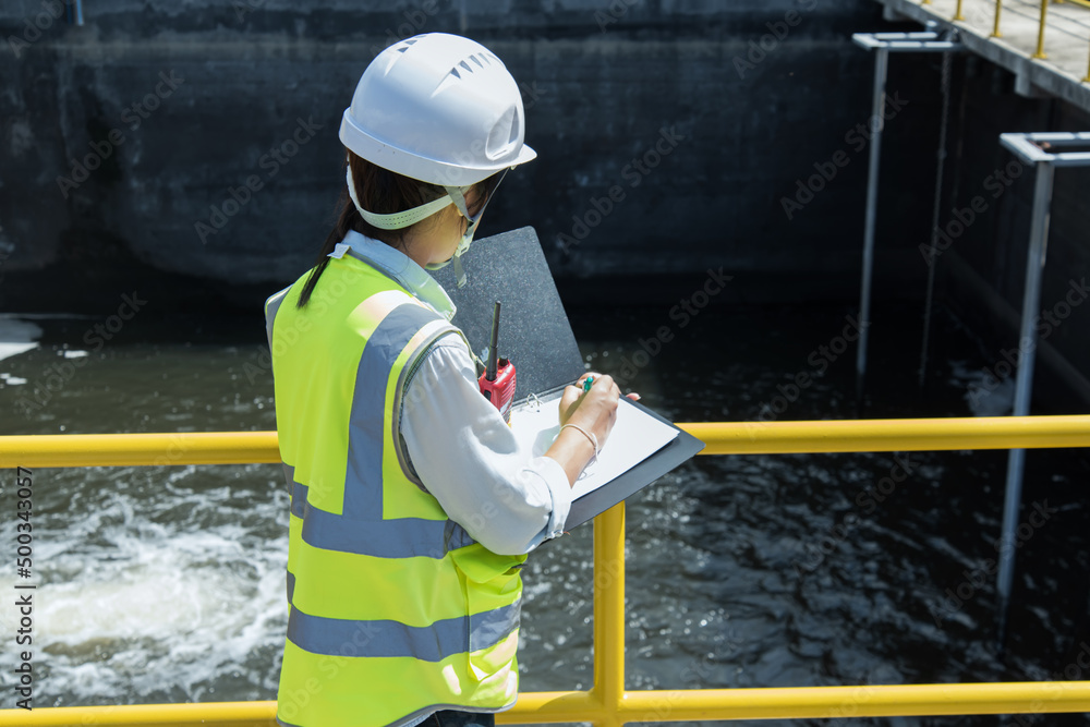 Wastewater treatment concept. Service woman engineer on waste water ...