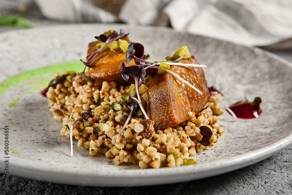 Roasted beef tongue with green buckwheat and green sauce. Main course ...