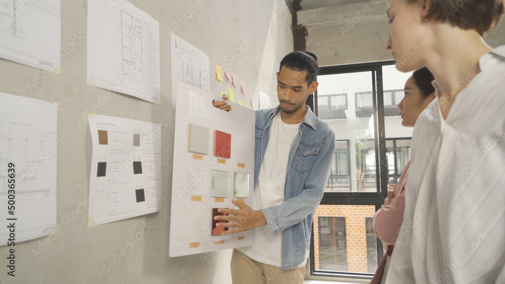 A group of multi ethnic business designer team talk, communicate ...