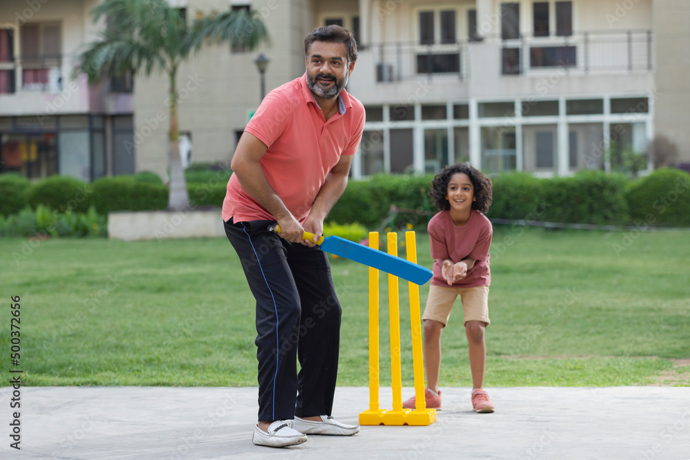 Family playing cricket in the park Stock Photo | Adobe Stock